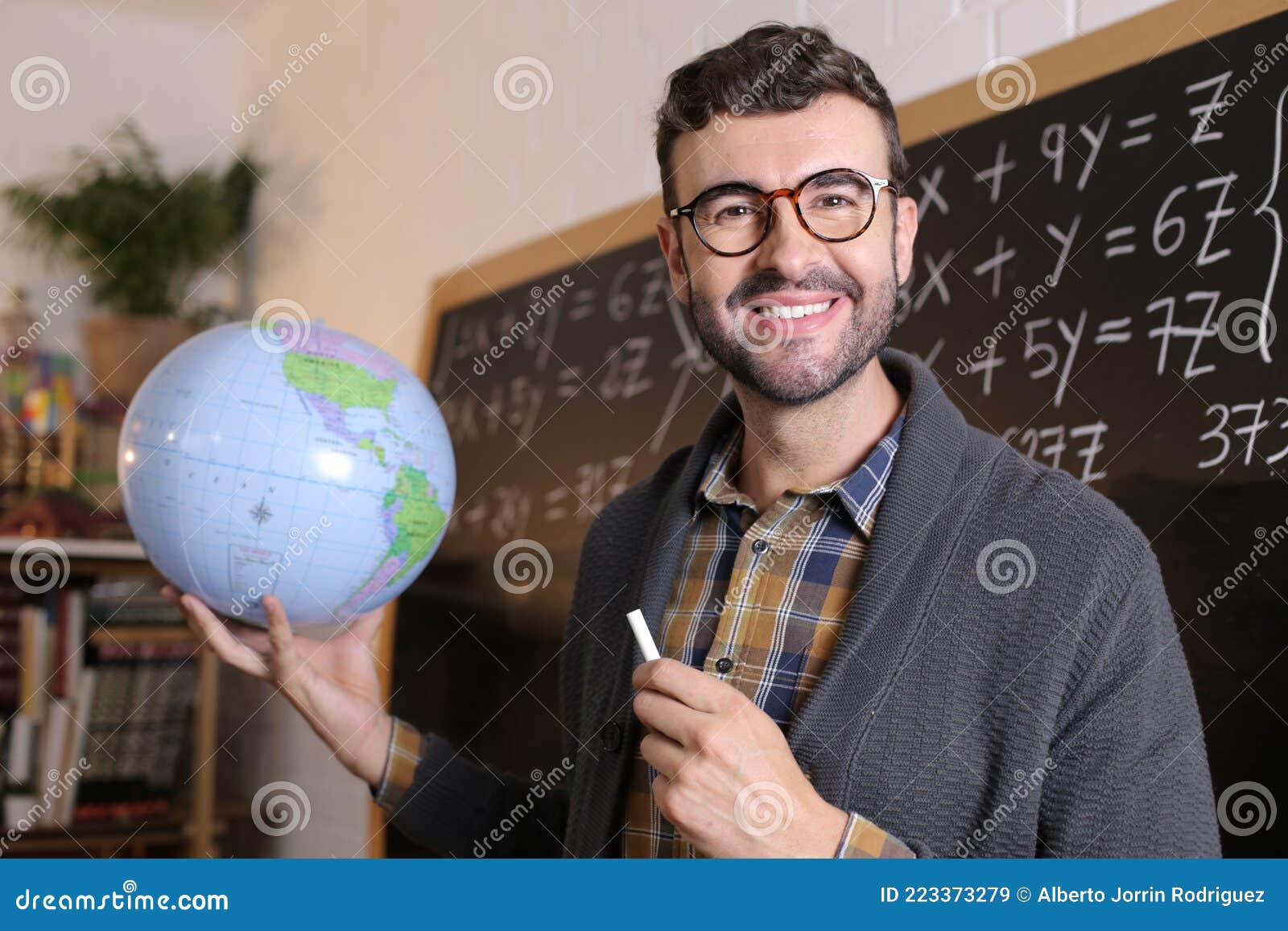 Geography Teacher Showing the Globe in Classroom Stock Image - Image of ...