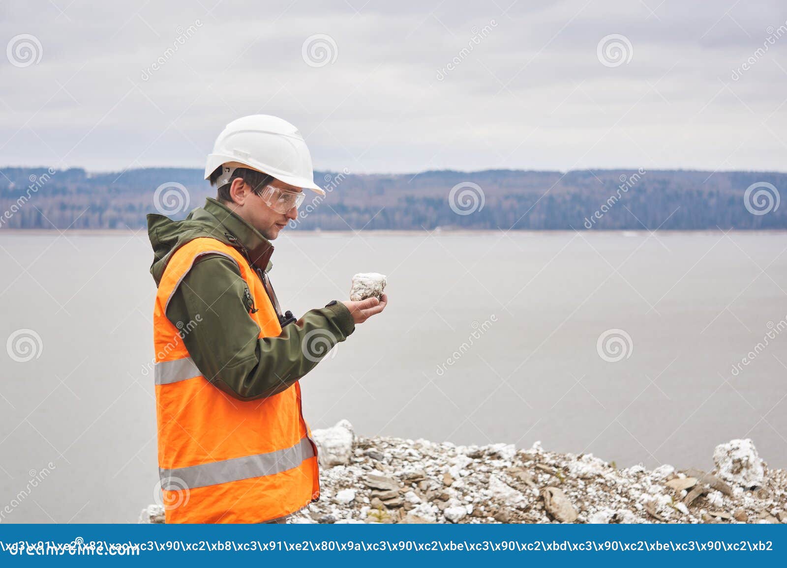 Geologist or Mining Engineer Examines a Sample of a Mineral from a ...