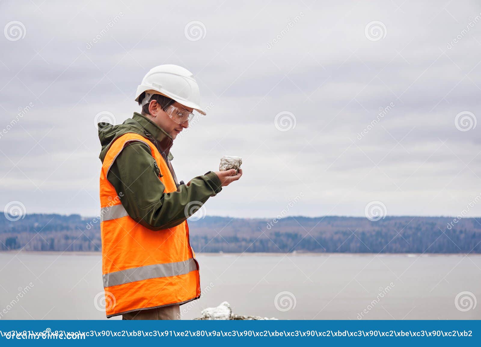 Geologist or Mining Engineer Examines a Sample of a Mineral from a ...