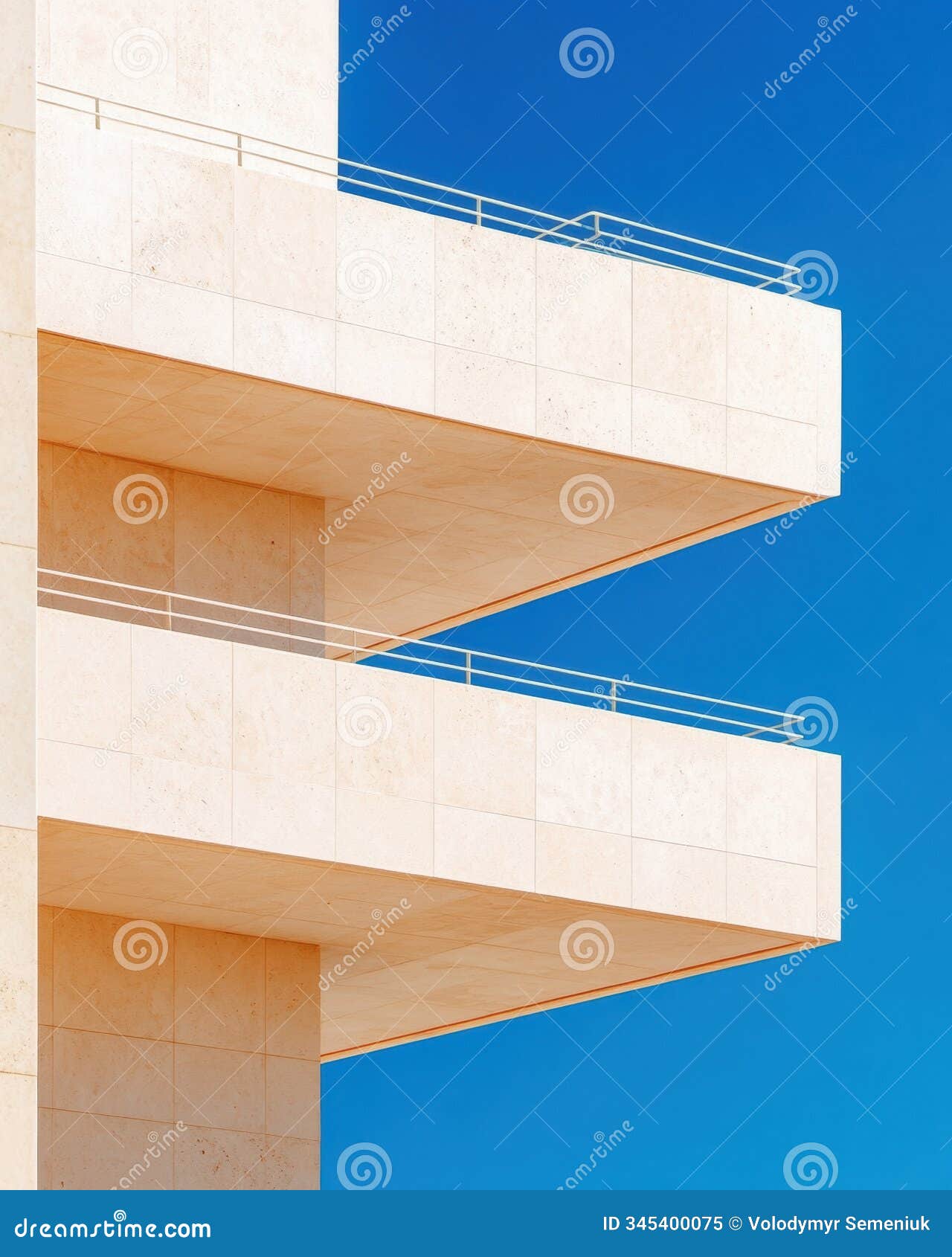 Geometric Building Design with Overhanging Balconies Under a Clear Blue ...
