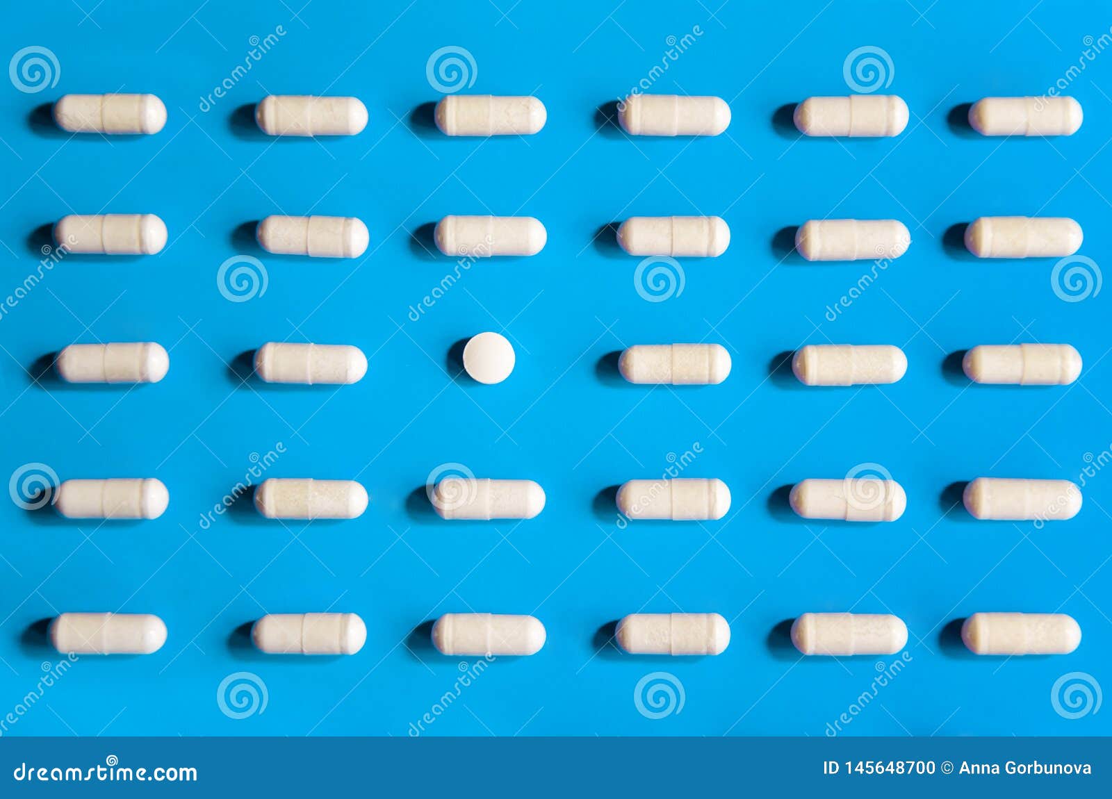 Geometric Pattern of White Vitamins in Capsules on Blue Background ...