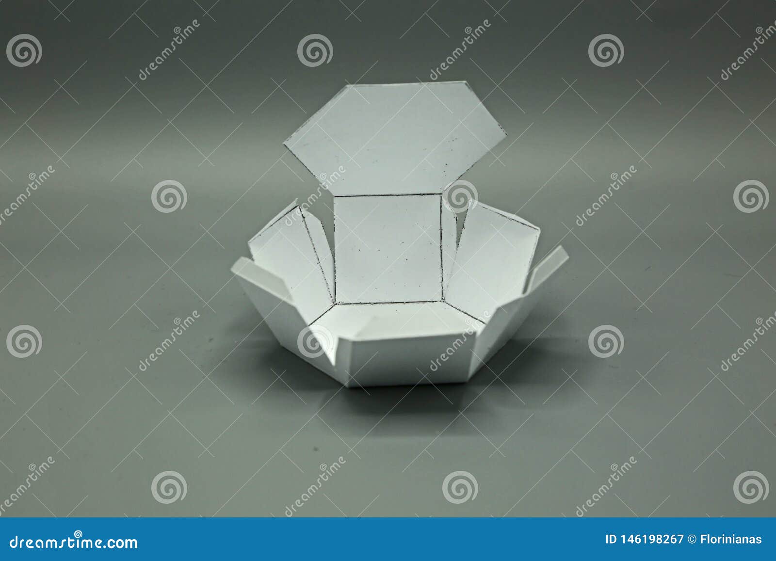 Geometric Shape Cut Out of Paper and Photographed on Grey Background ...
