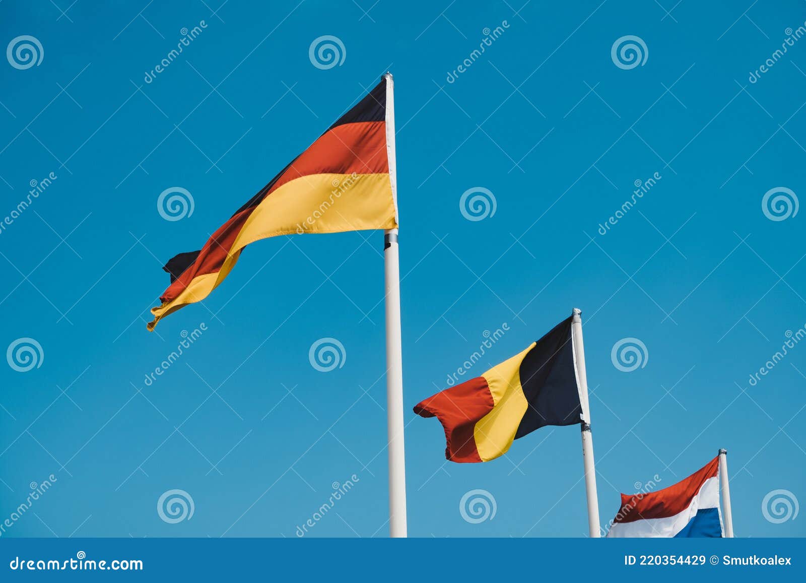 German, Belgium and French Flags Waving on the Wind Editorial Stock ...
