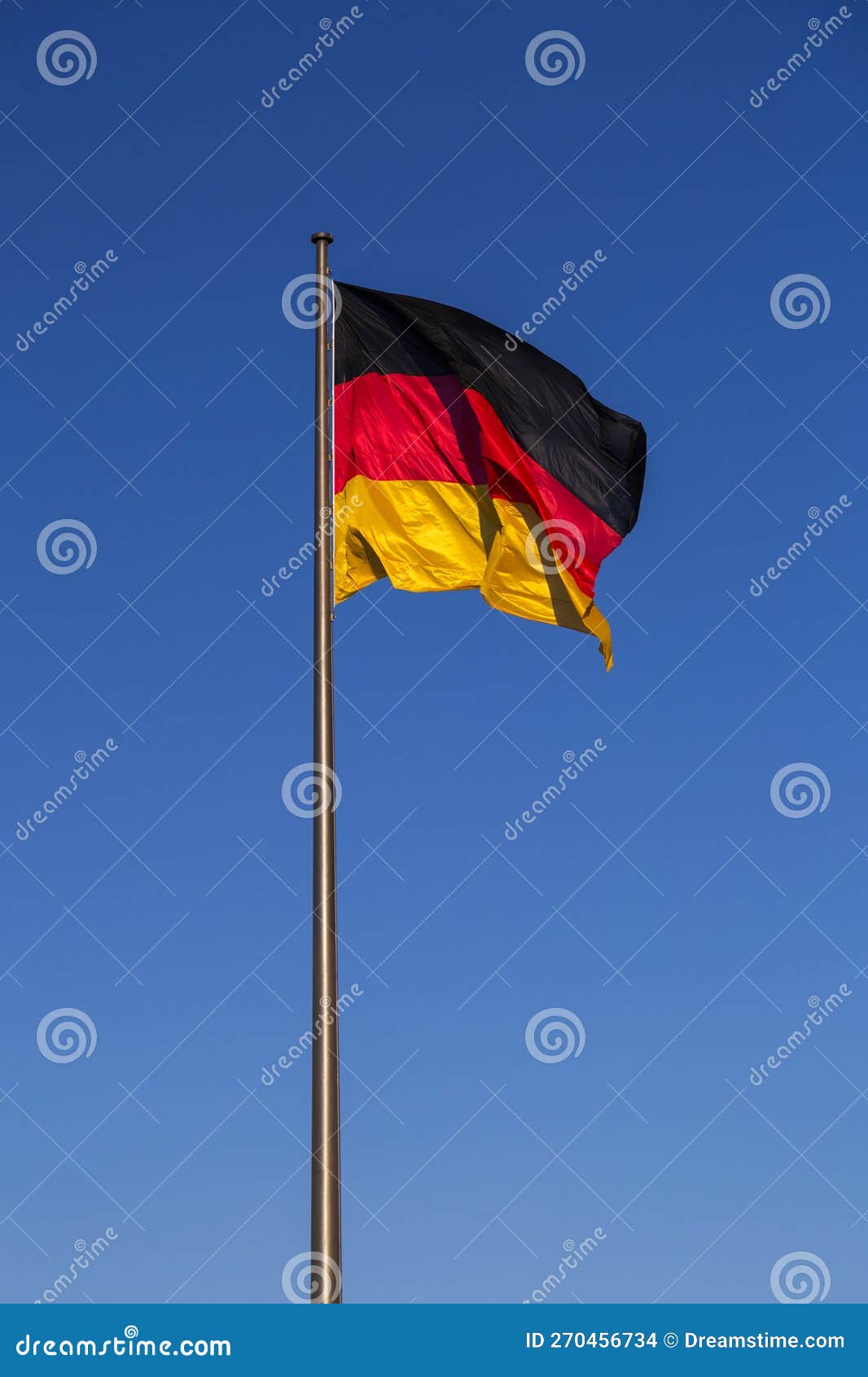German Flag on a Flagpole Against the Blue Sky Stock Photo - Image of ...