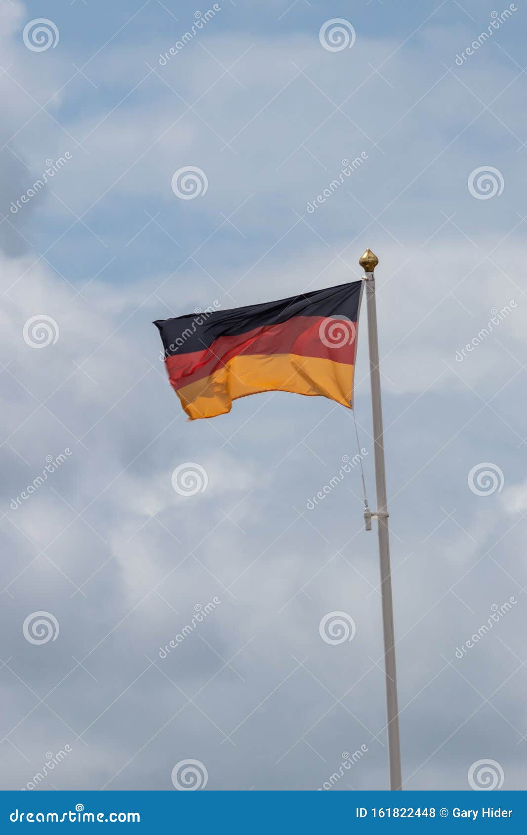 A German Flag Flying from a Flagpole Stock Photo - Image of wind ...