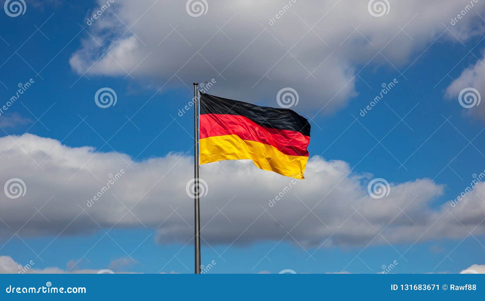 German Flag Waving on a Flagpole Against Blue Sky with Clouds, Stock ...