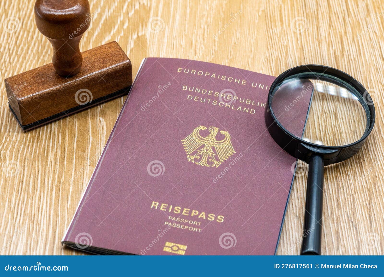 A German Passport is Stamped on a Wooden Table in an Official Process ...