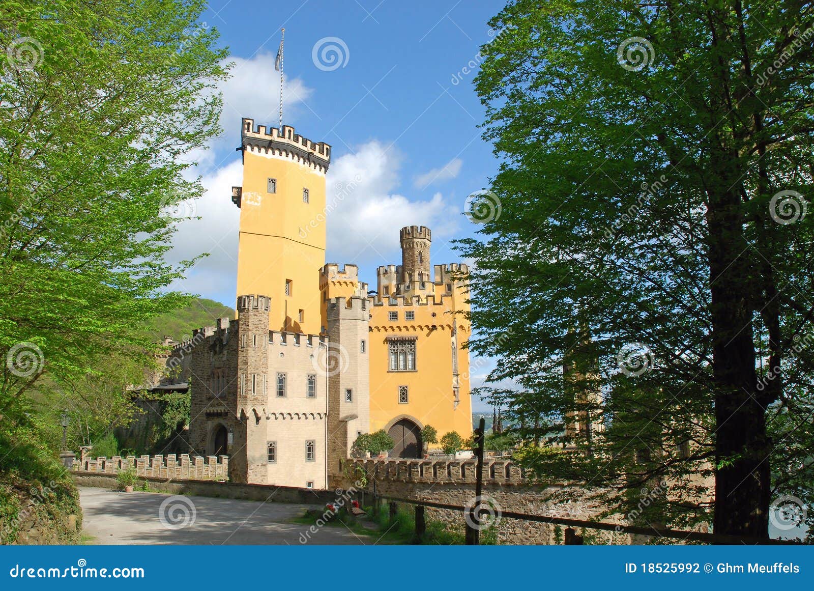 Yellow Castle With A Tall Tower That Is Reflected In The Moat Royalty ...