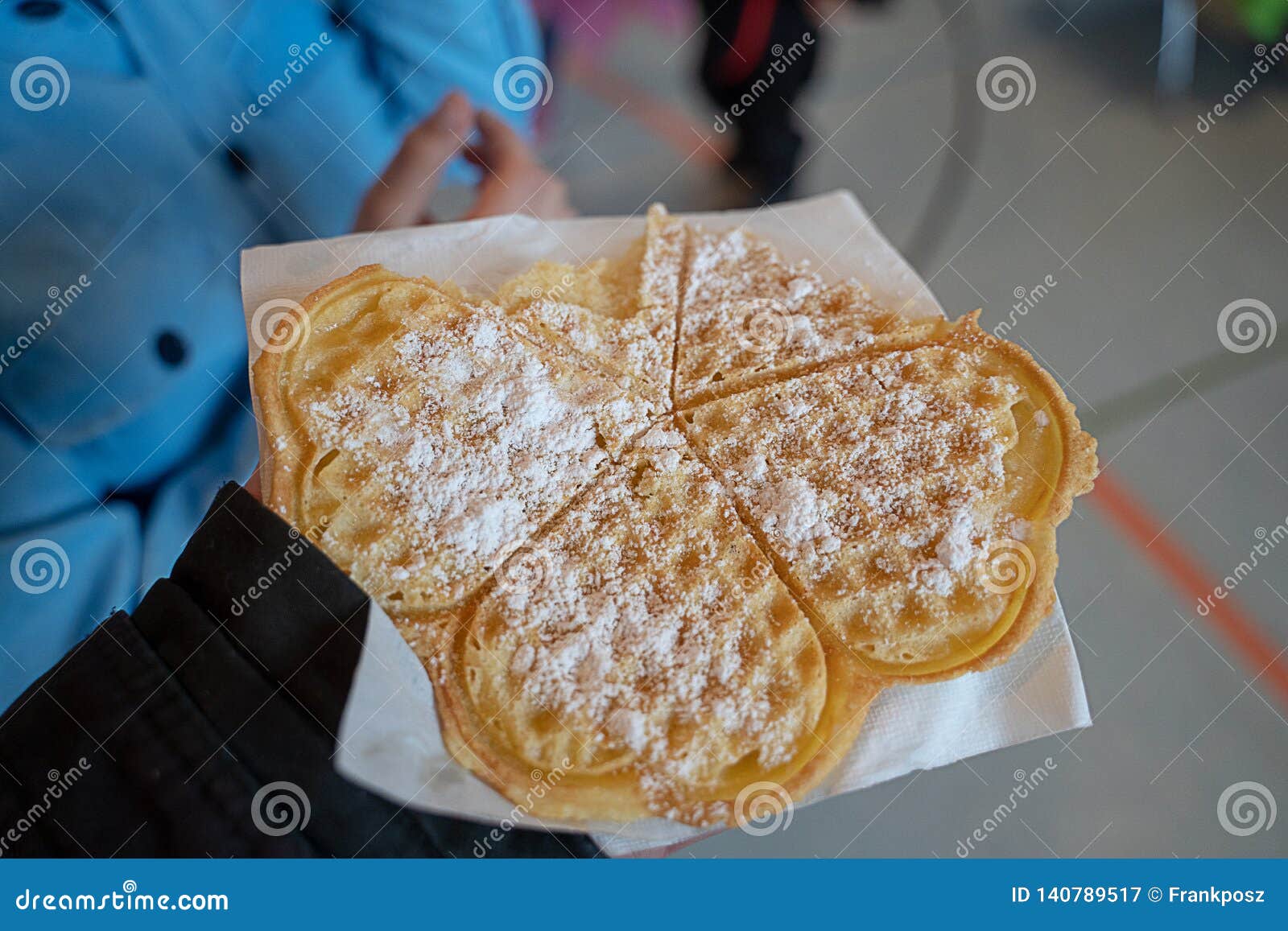 A German Typical Waffle in a Hand with Powdered Sugar Stock Image ...