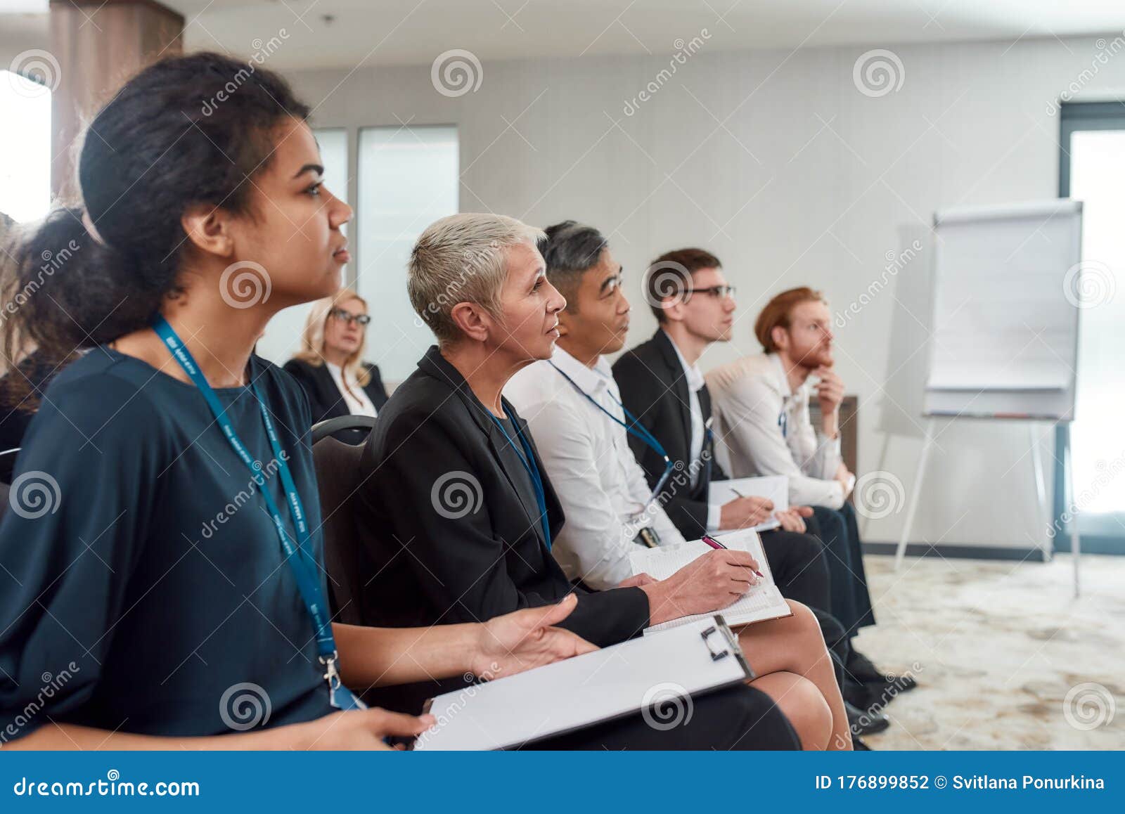 Get Together. Multi-ethnic Audience Sitting in a Row while Listening To ...