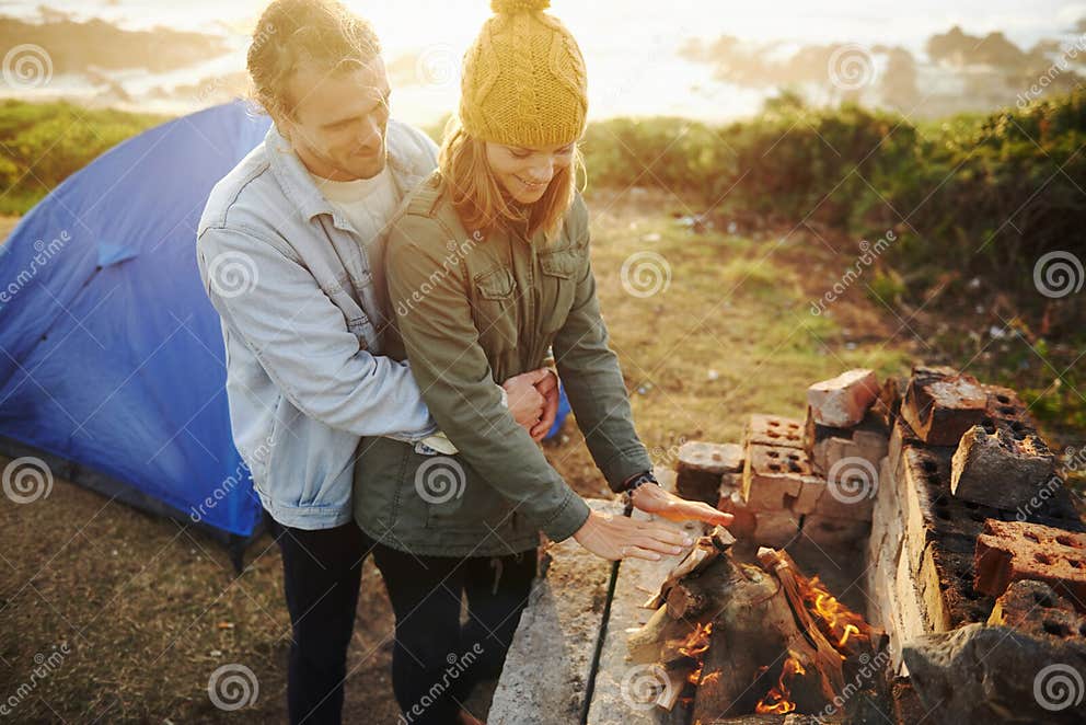 Getting the Campfire Started. an Affectionate Young Couple Getting Warm ...