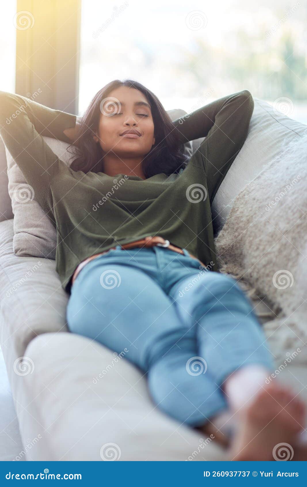 Getting Comfortable on the Sofa. an Attractive Young Woman Relaxing on ...