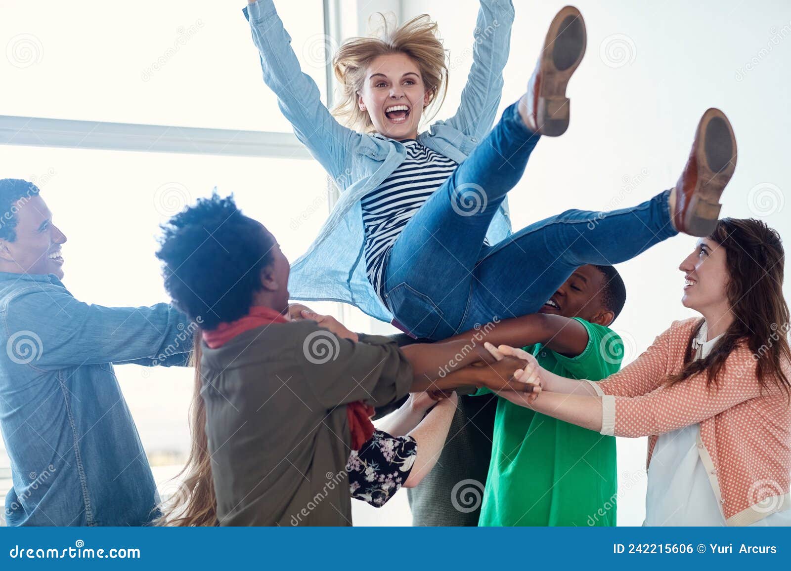 Getting Crazy on Campus. Shot of a Group of University Students Tossing ...