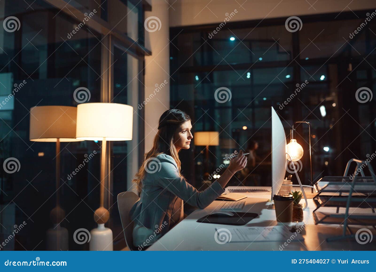 Getting it Done Whatever the Hour. a Young Businesswoman Using a ...