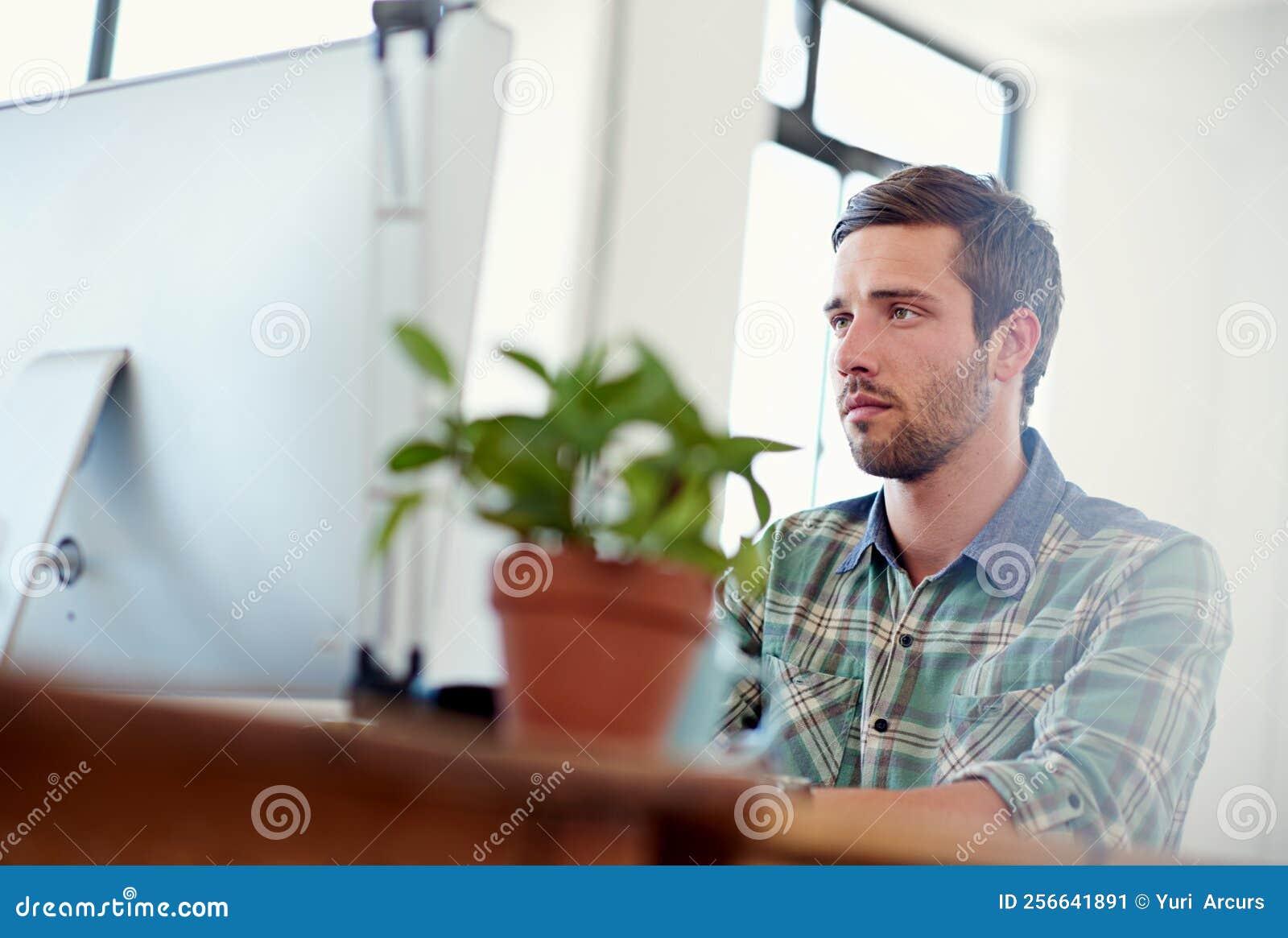 Getting Down To Business. a Casually-dressed Young Man at Work on a ...