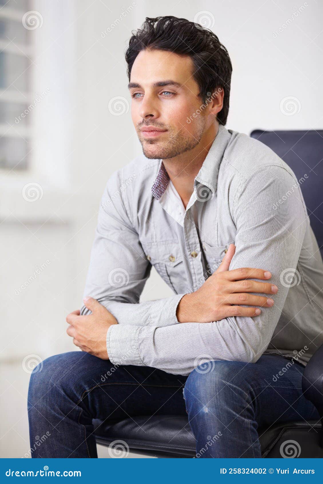 Getting Down To Business. a Handsome Young Sitting in a Chair. Stock ...