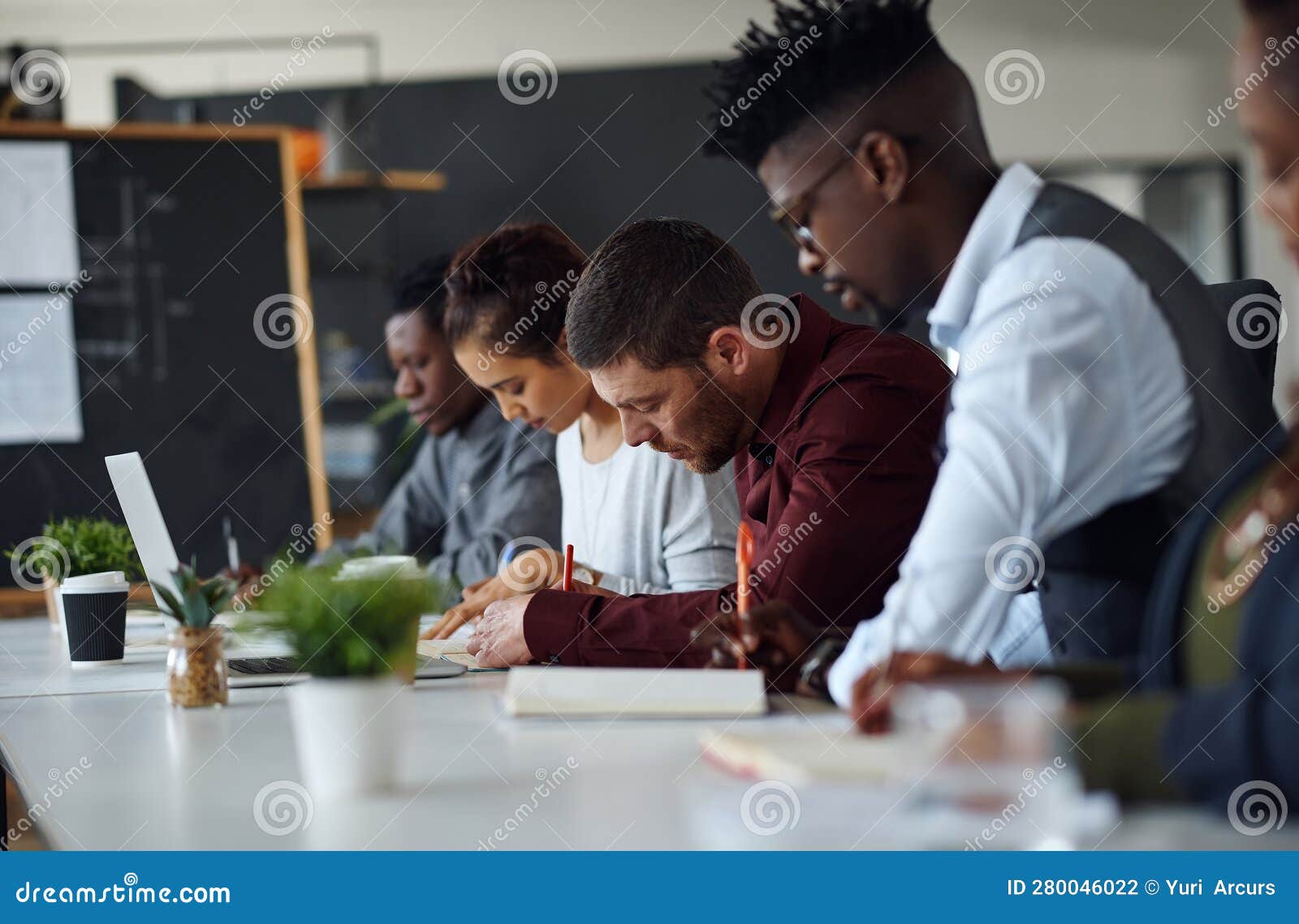 Getting Down To Work. a Group of Businesspeople Listening To a ...