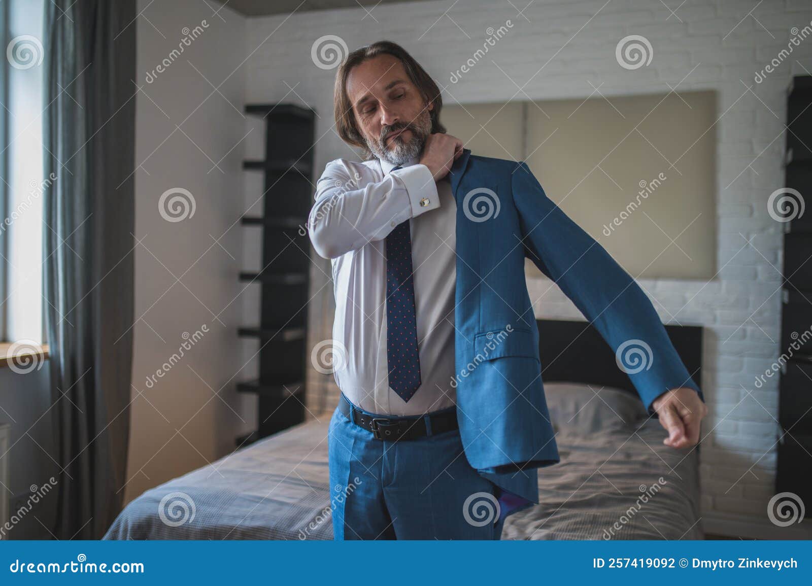 Bearded Good-looking Man Putting on His Jacket Stock Photo - Image of ...