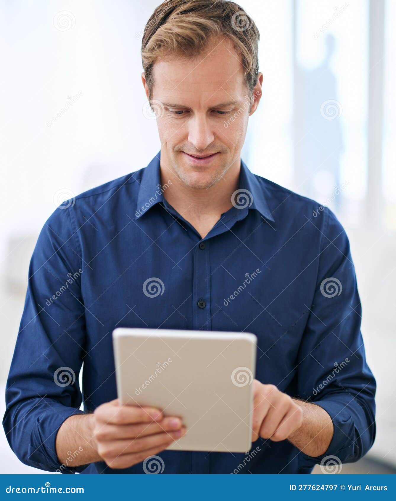 Getting those Emails Out of the Way. a Handsome Man Using His Tablet at ...