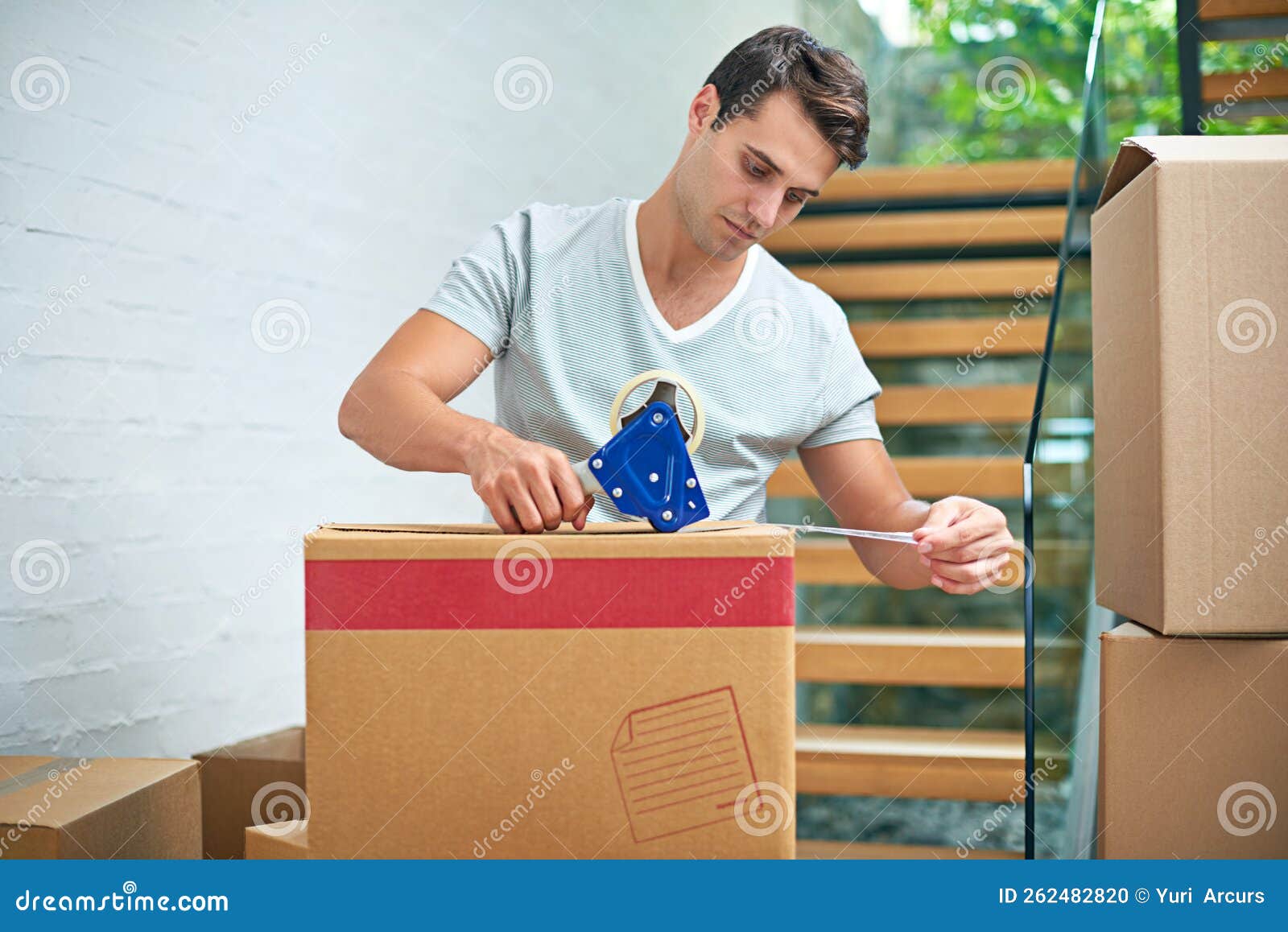 Getting Everything Ready for the Move. a Young Man Packing Up His ...