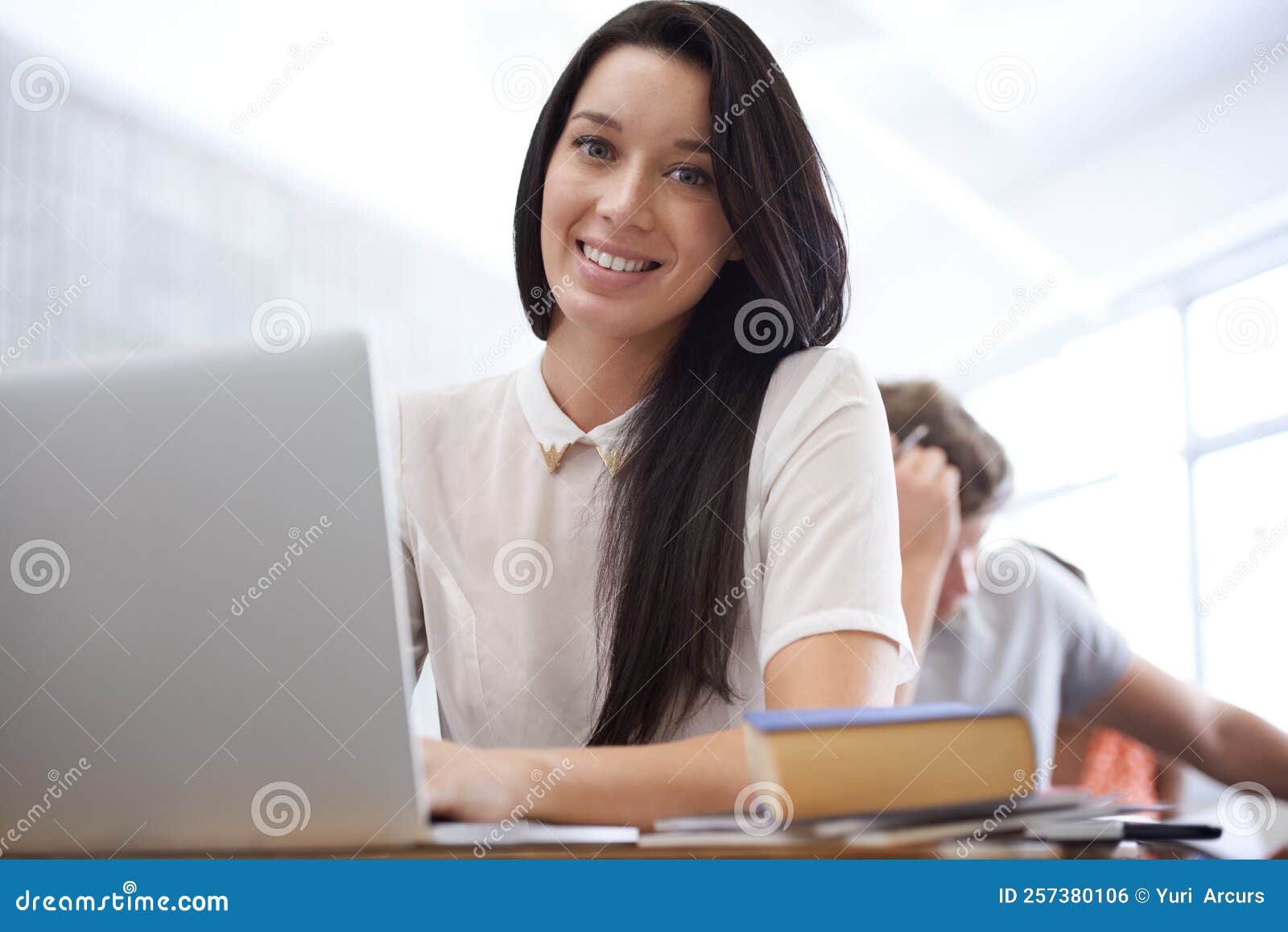 Getting the Grades she Wants. a Happy Young College Student Working at ...