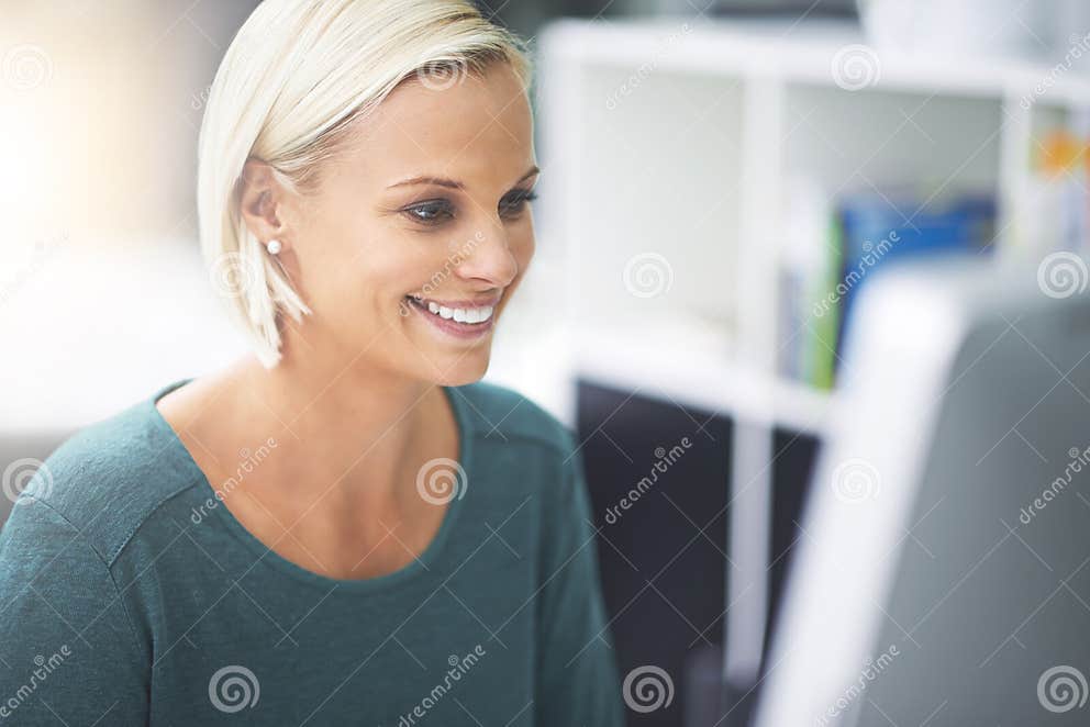 Getting Her Work Done with a Smile. a Businesswoman Working on Her ...