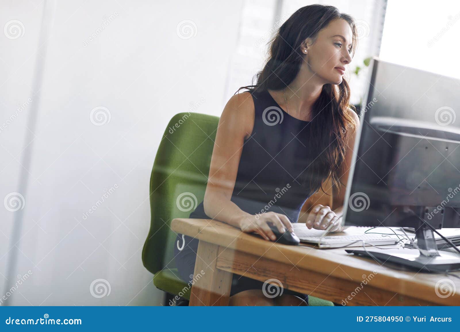 Getting Her Work Done on Time. a Young Woman at Work on Her Computer in ...