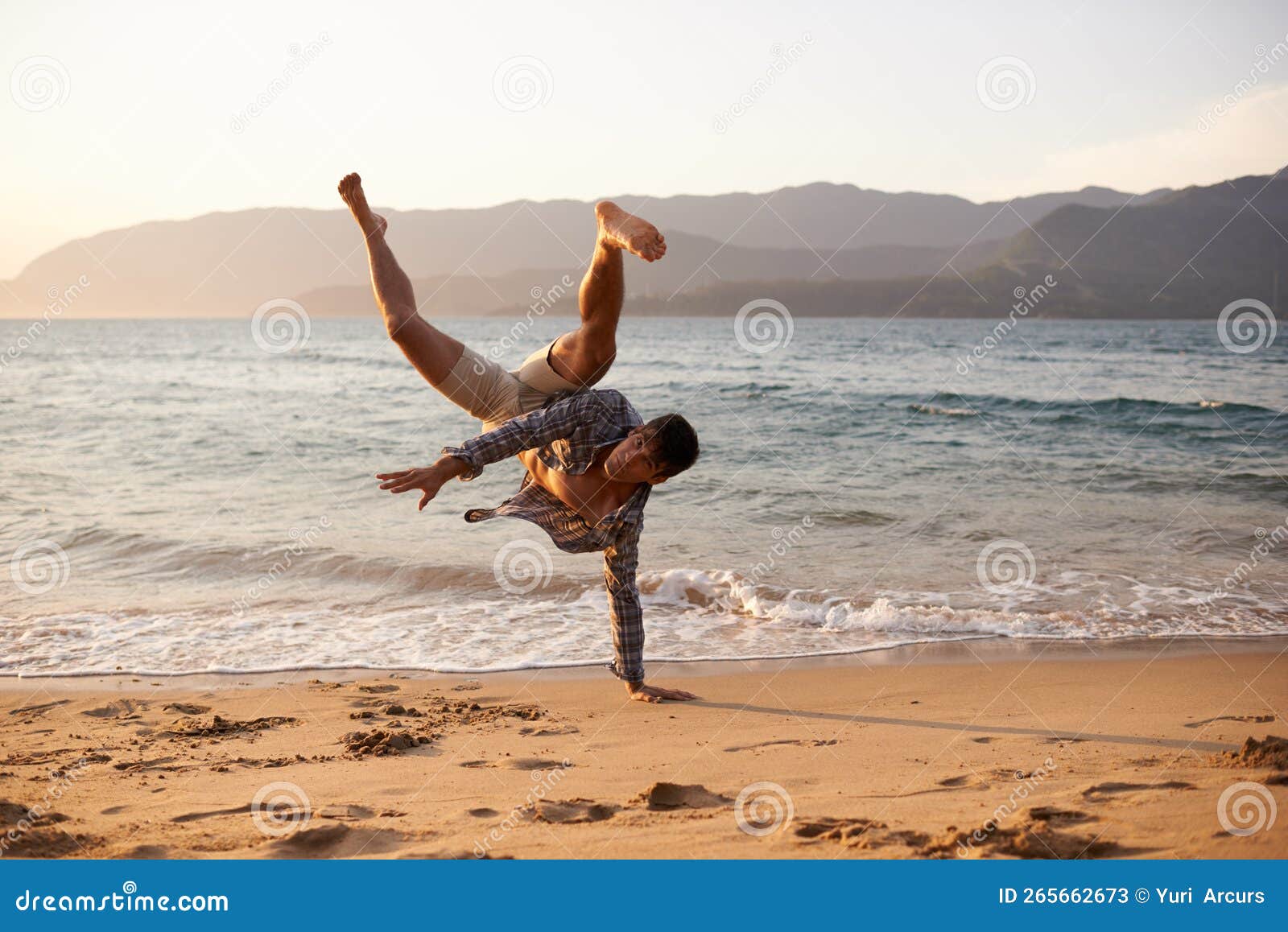 Getting His Breakdance on. a Young Man Dancing on the Beach. Stock ...