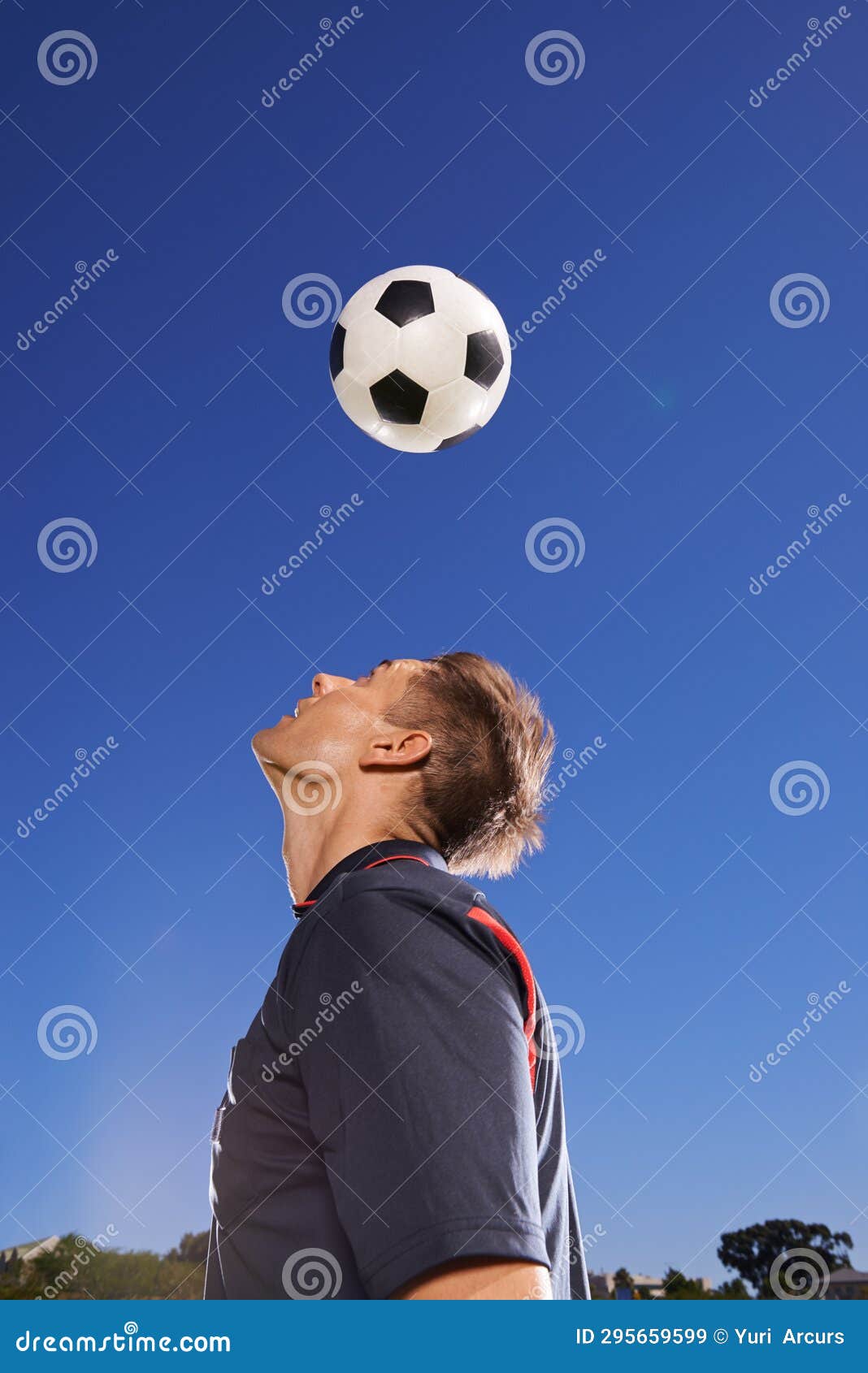 Getting His Head in the Game. a Young Footballer Bouncing a Ball on His ...