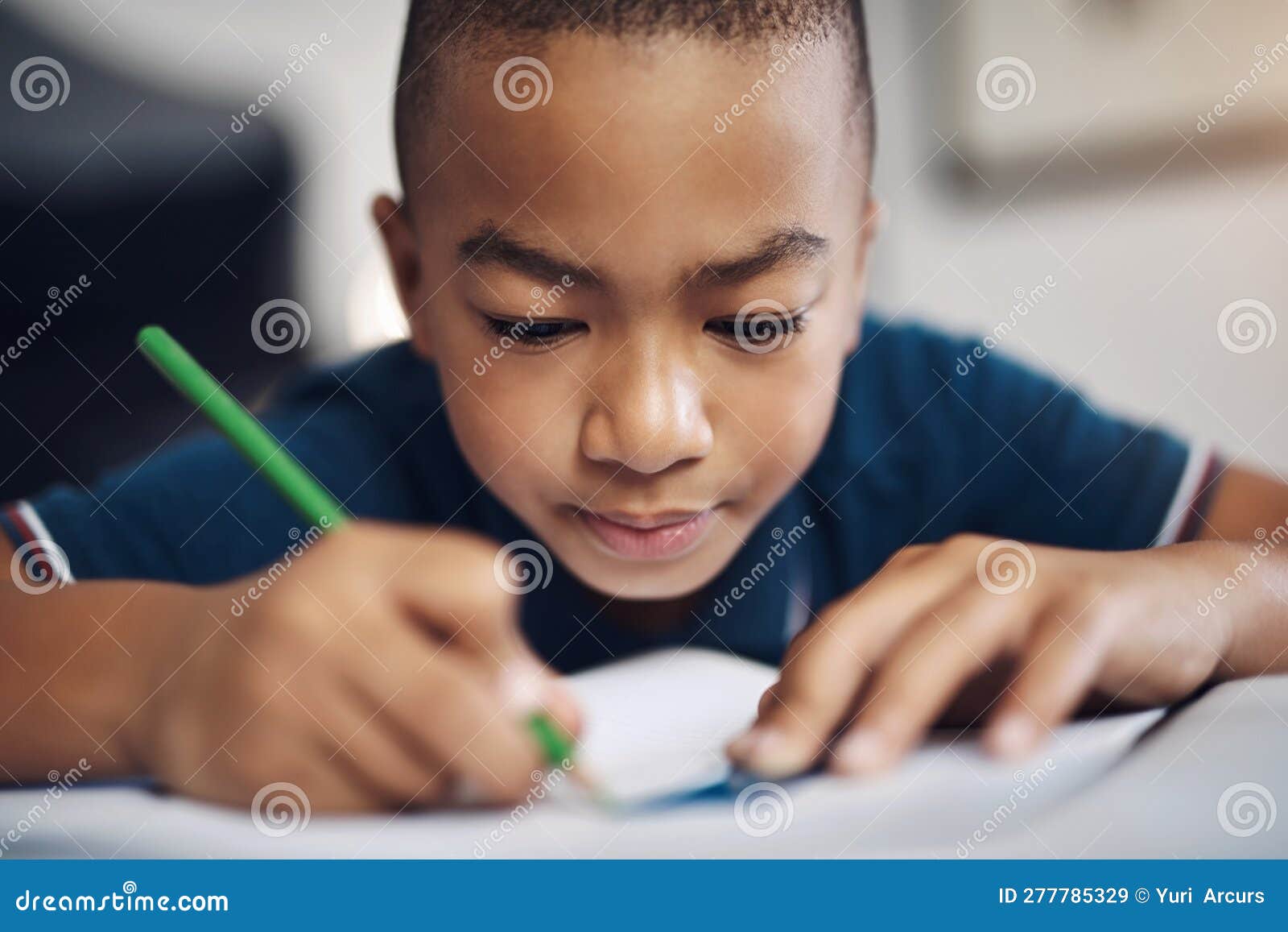 Getting His Homework Done before Playtime. a Young Boy Using Colouring ...