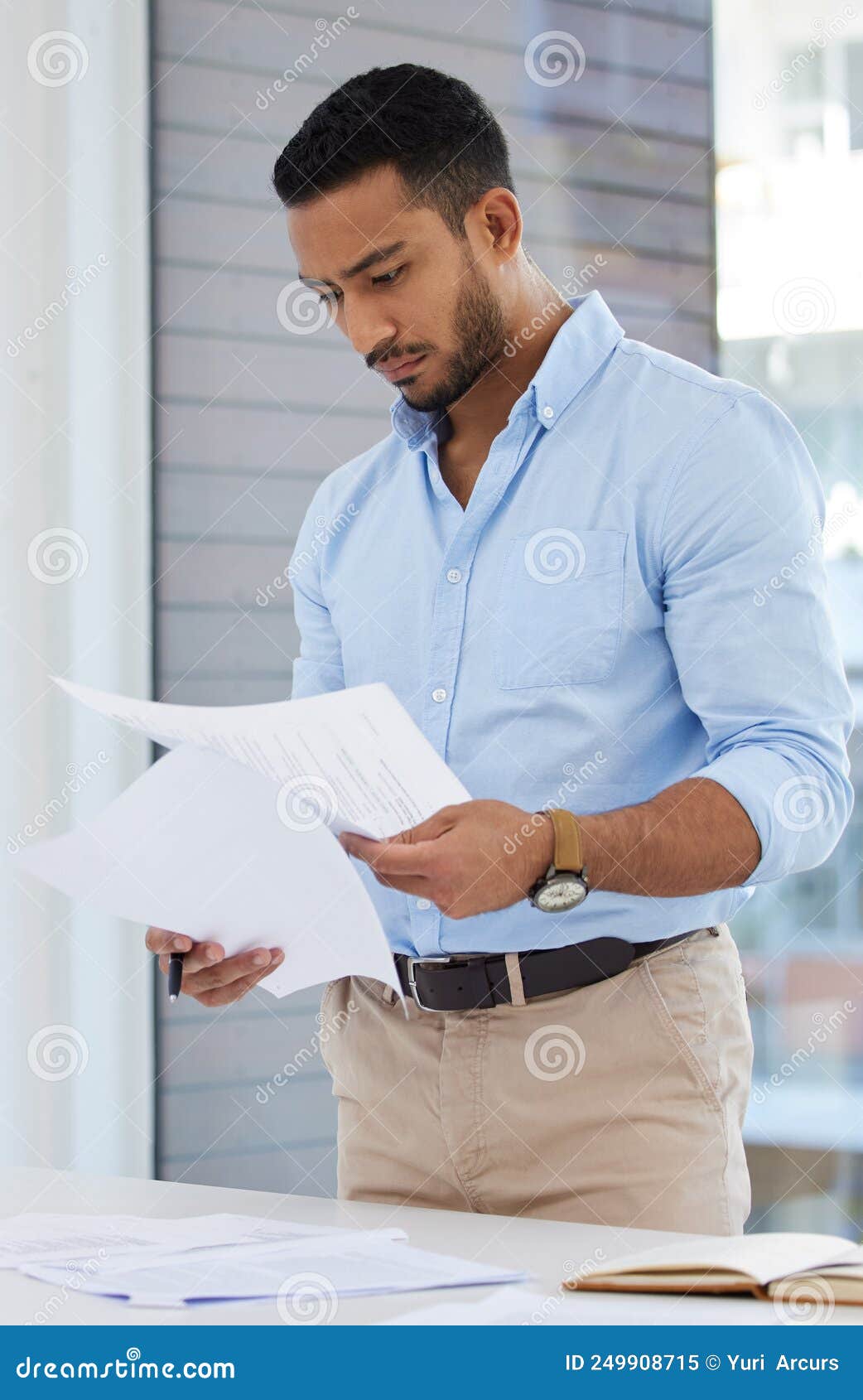 Getting His Paperwork in Order. Shot of a Young Businessman Going ...