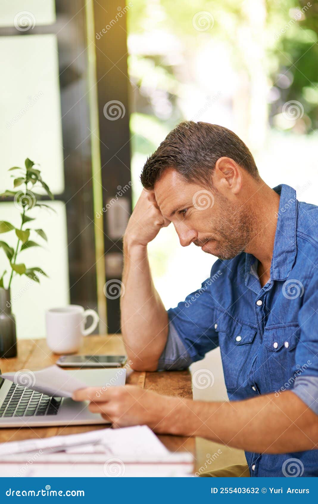 Getting His Work Done from Home Today. a Man Looking Over Some ...