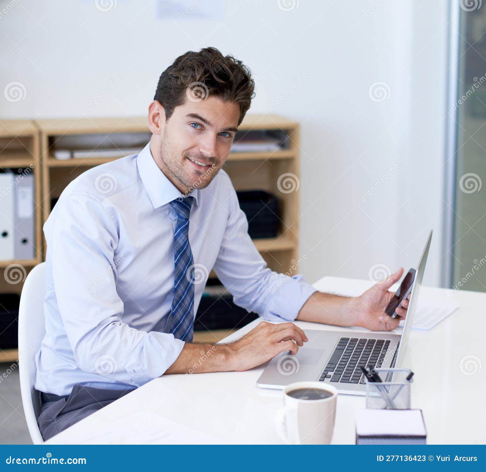 Getting this Information Down. a Handsome Young Businessman Working in ...