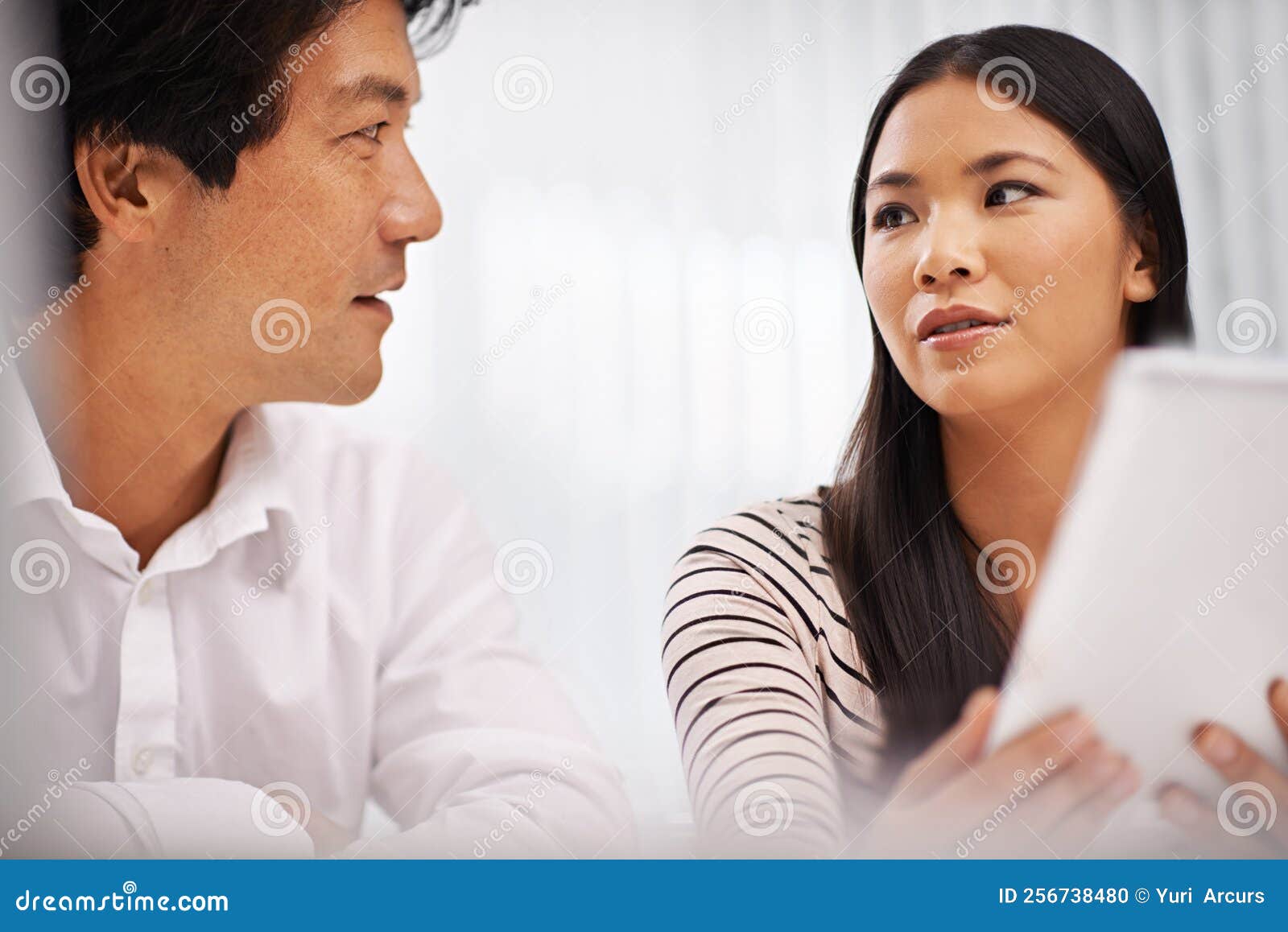 Getting Input from a Colleague. Two Asian Business Colleagues Sitting ...