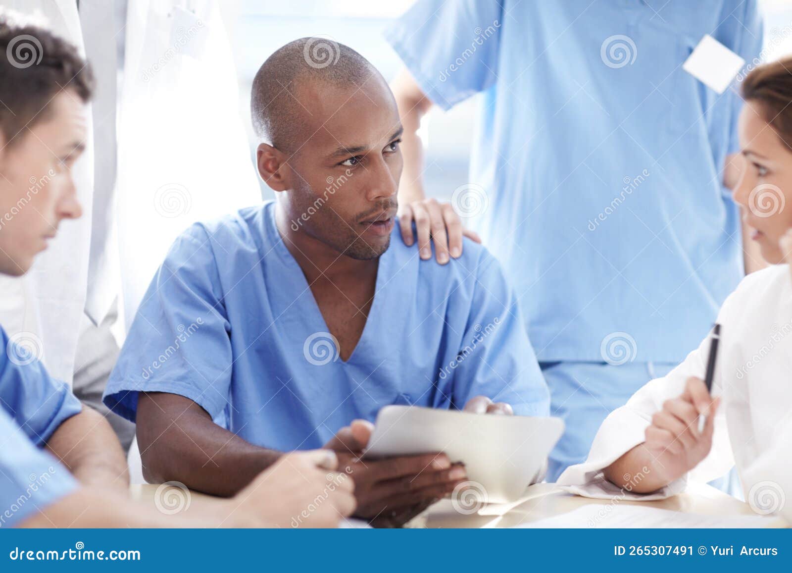 Getting Input from the Team. a Doctor and His Colleagues Have a ...