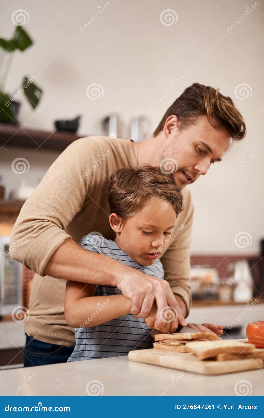 Getting Lunch Ready. a Young Boy Making a Sandwich with the Help of His ...