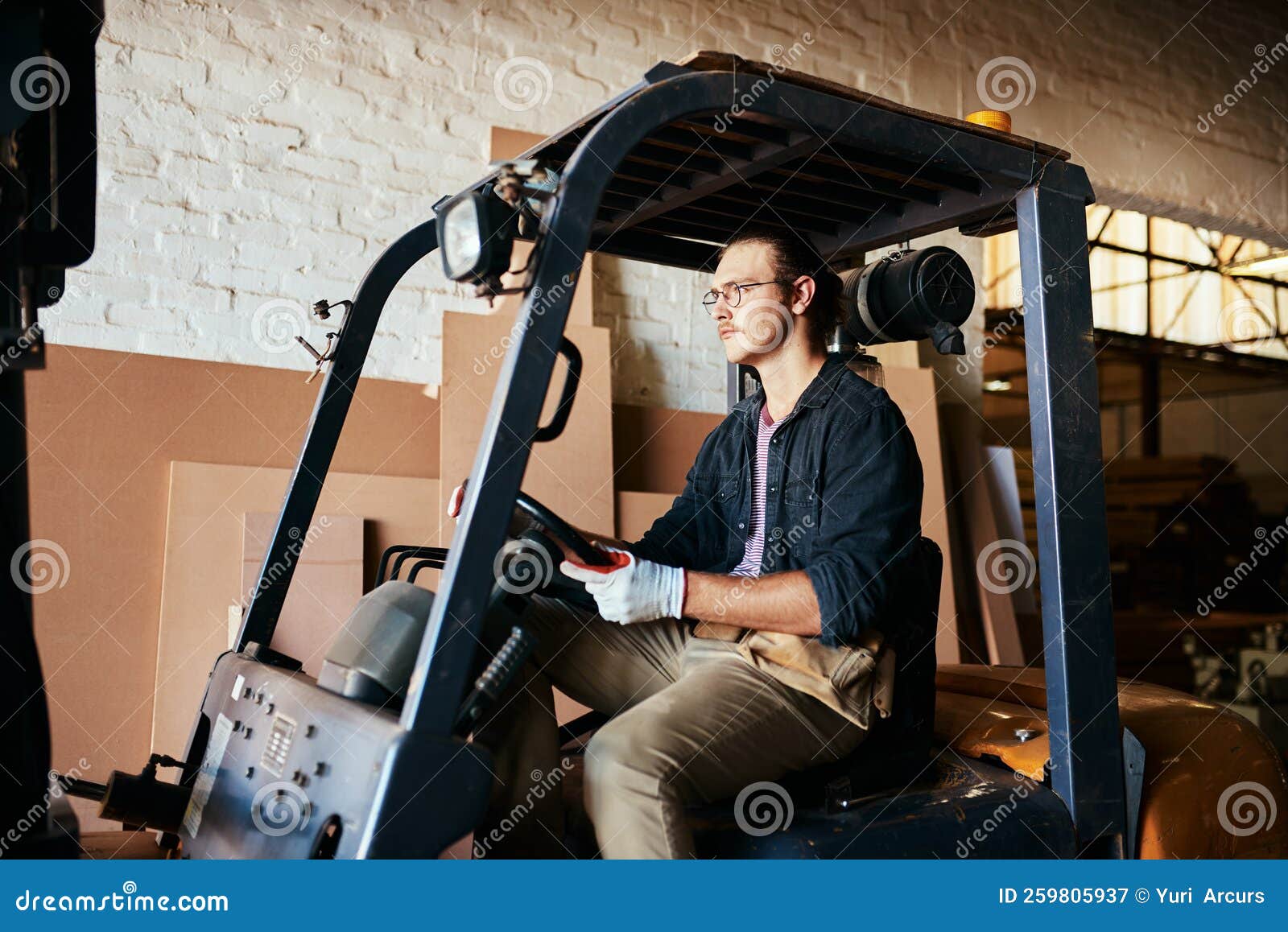 Getting Orders on the Move. a Handsome Young Man Driving a Forklift ...