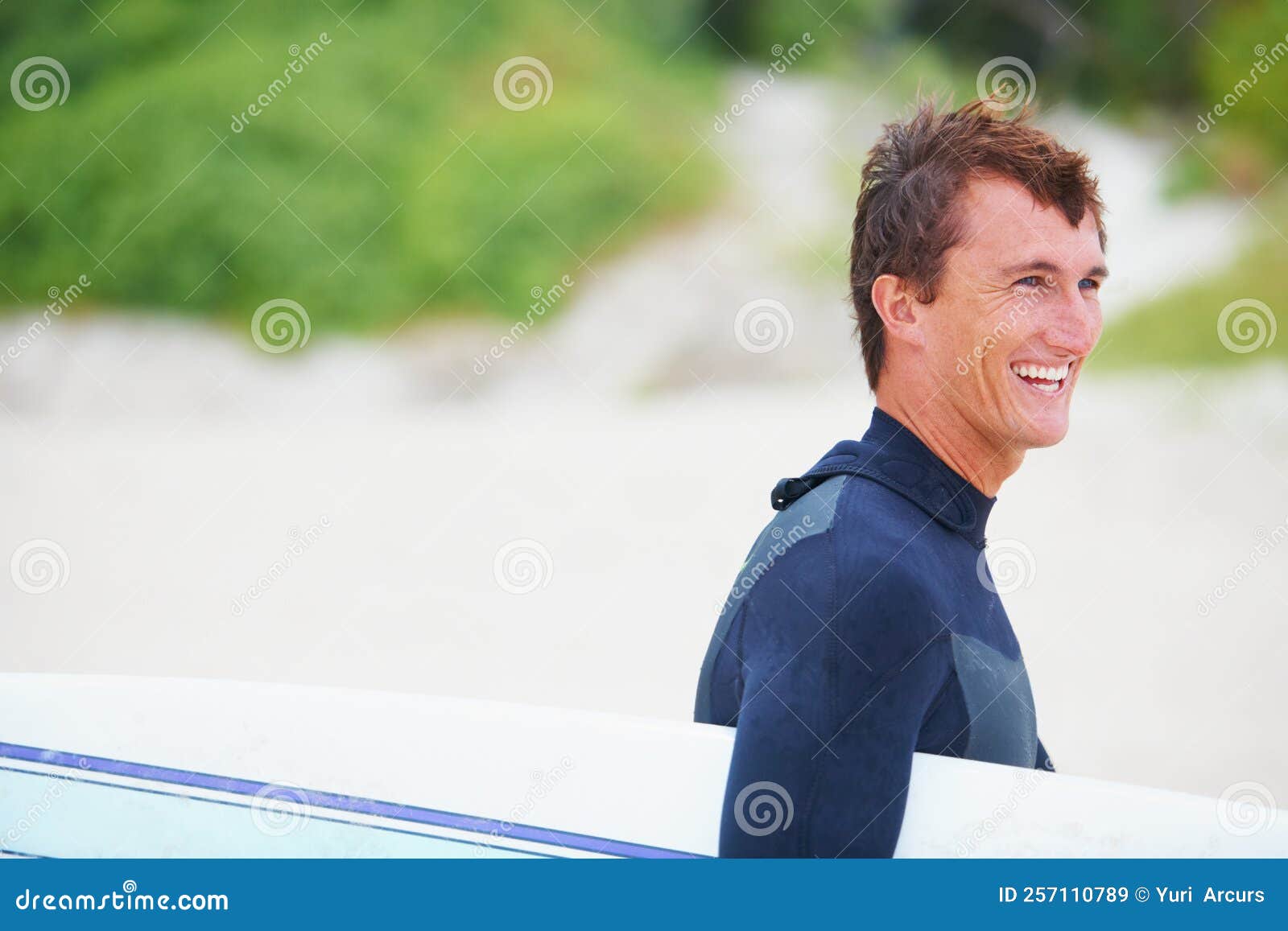 Getting Out on the Waves. a Young Surfer Carrying His Board on the ...