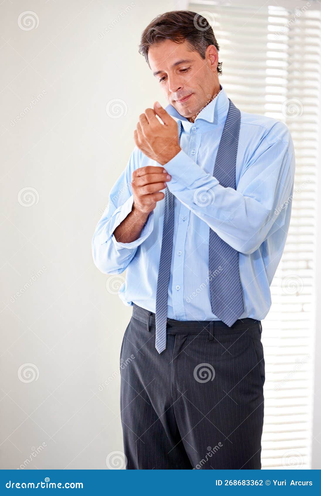 Getting Ready for Another Day at the Office. a Mature Businessman ...