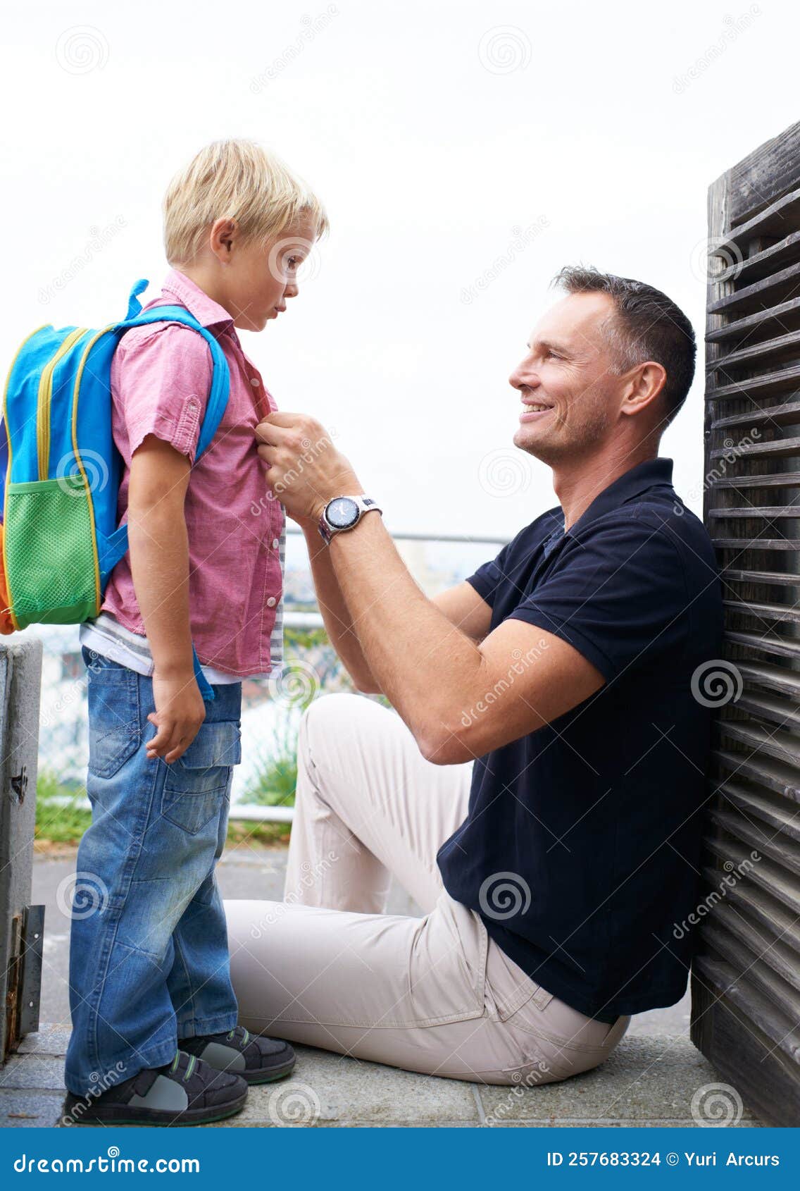 Getting Ready for His First Day at School. a Father Helping His Son Get ...