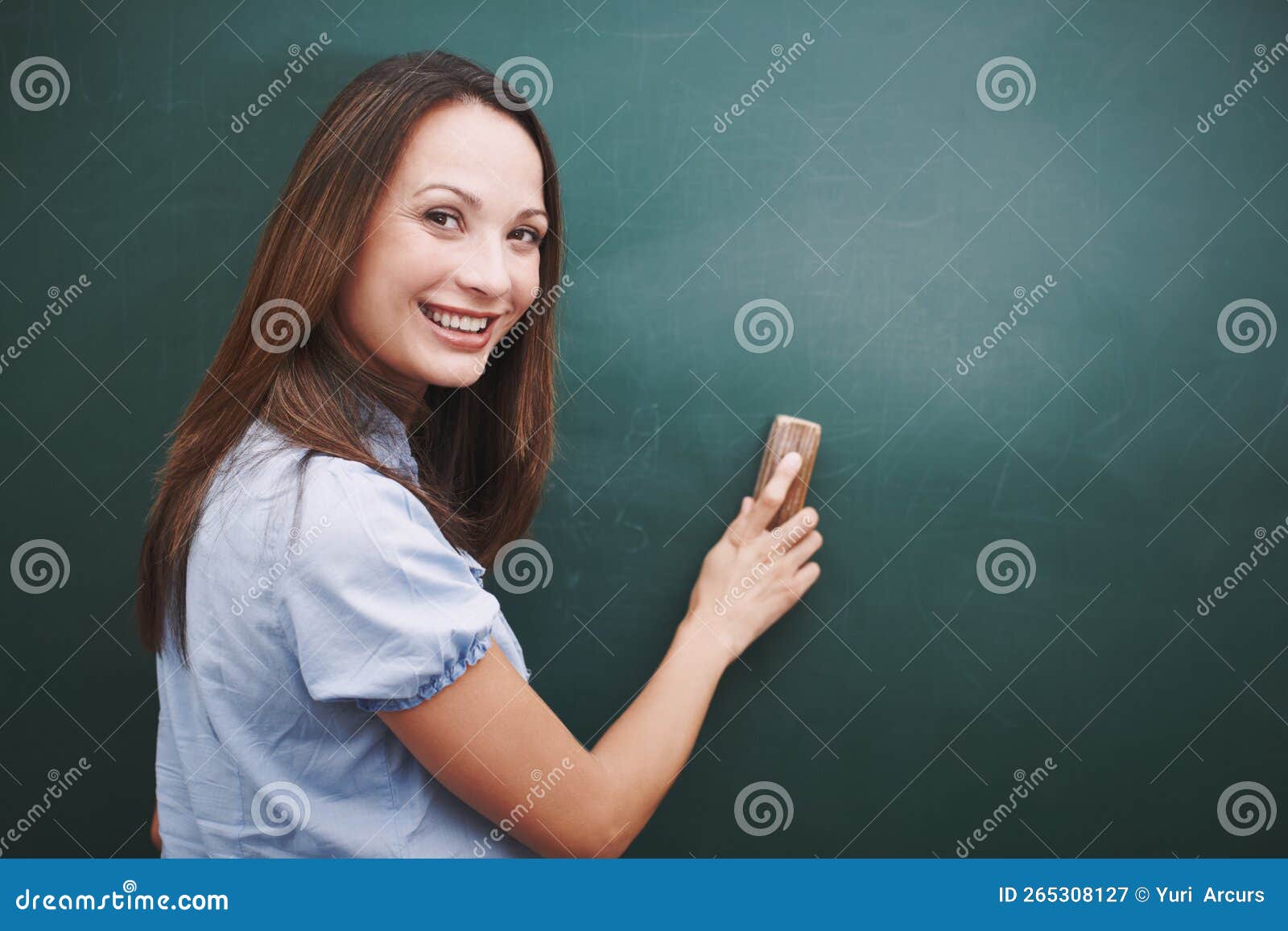 Getting Ready for a Lesson. a Beautiful Young Teacher Using the Eraser ...