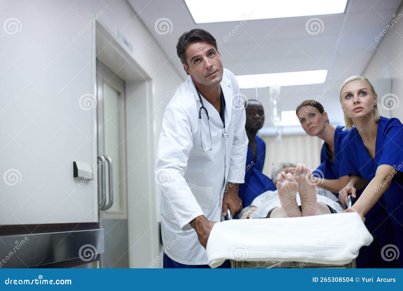 Getting Ready for Surgery. a Team of Doctors Pushing a Patient Down the ...