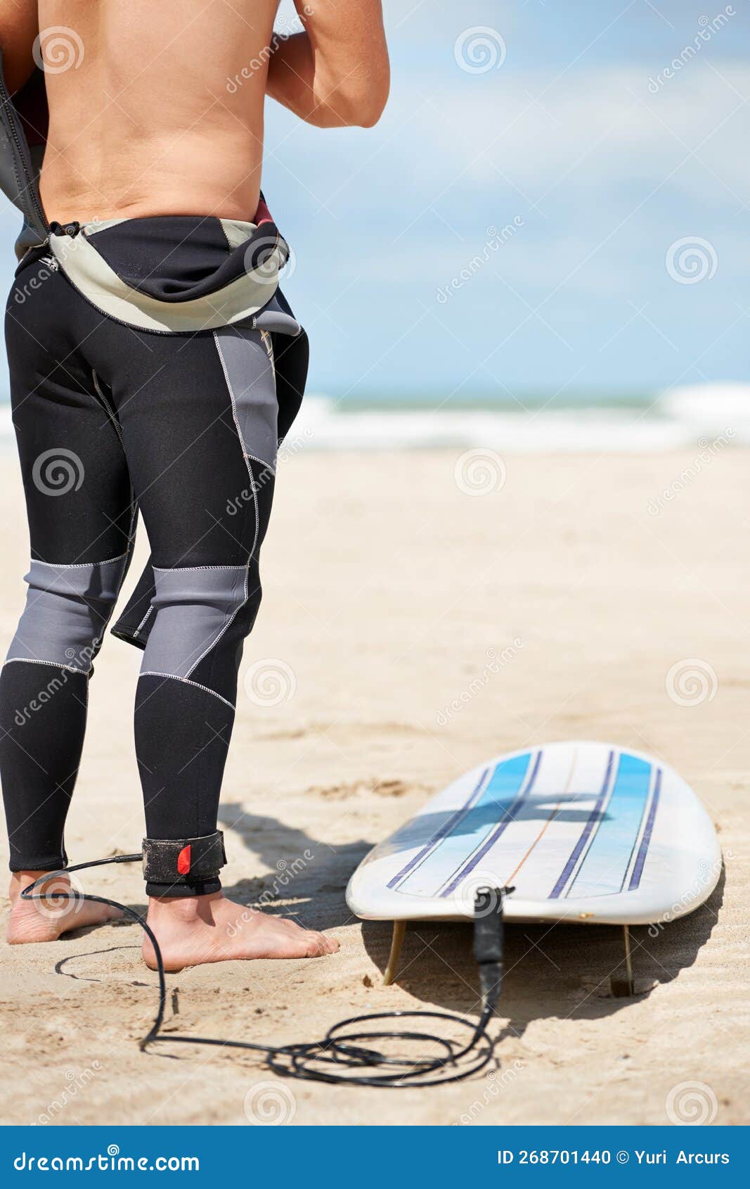 Getting Ready To Go Surfing. a Young Man in a Wetsuit Getting Ready for ...