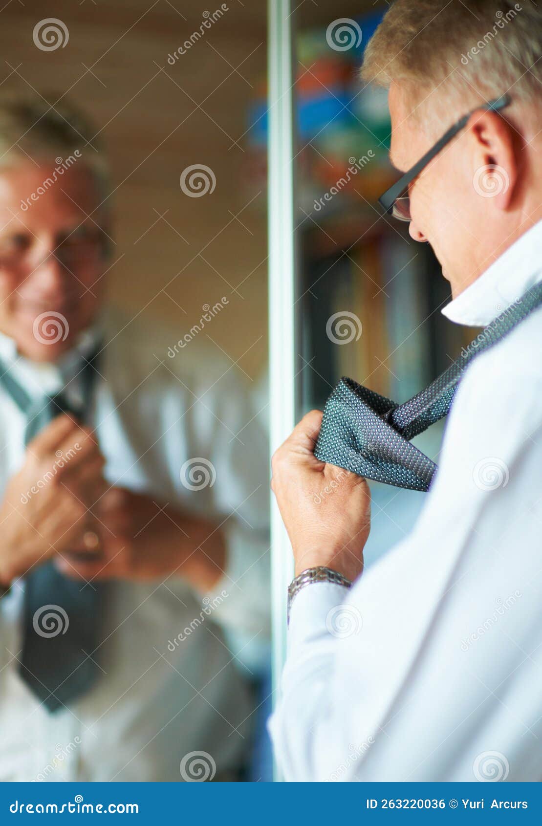 Getting Ready for Work. a Senior Man Getting Ready for Work in the ...