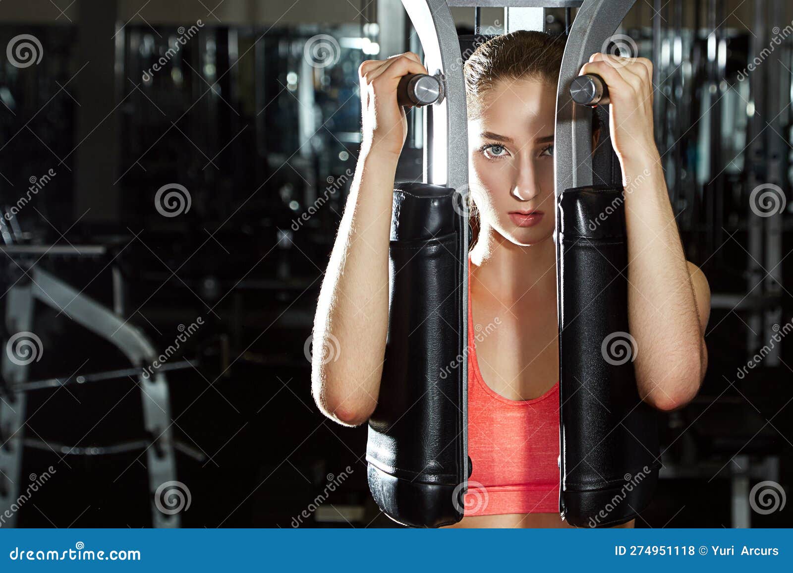 Getting Stronger with Each Workout. a Young Woman Using an Exercise ...
