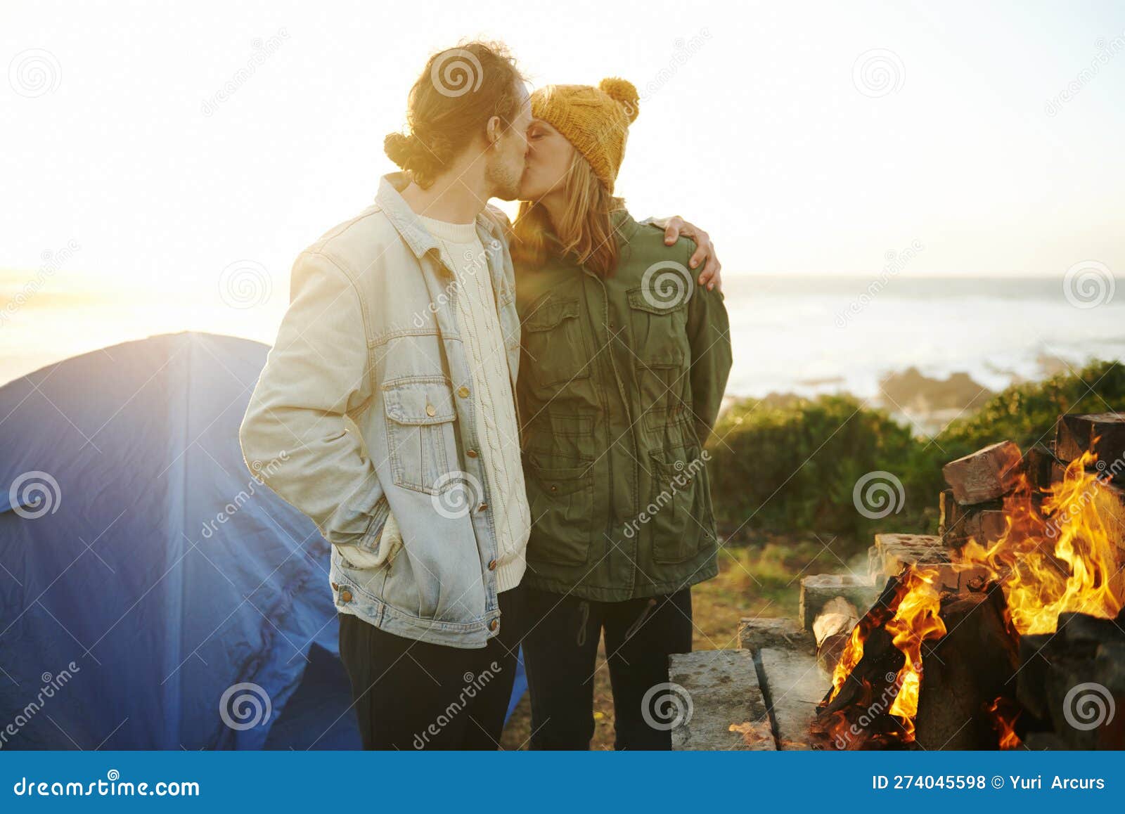 Getting Their Camp Warmed Up. an Affectionate Young Couple Getting Warm ...