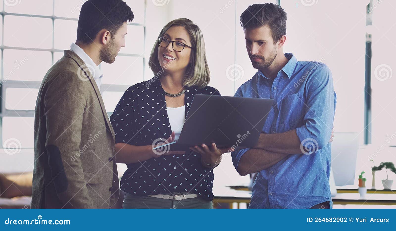 Getting Their Input. a Group of Young Designers Working on a Laptop in ...
