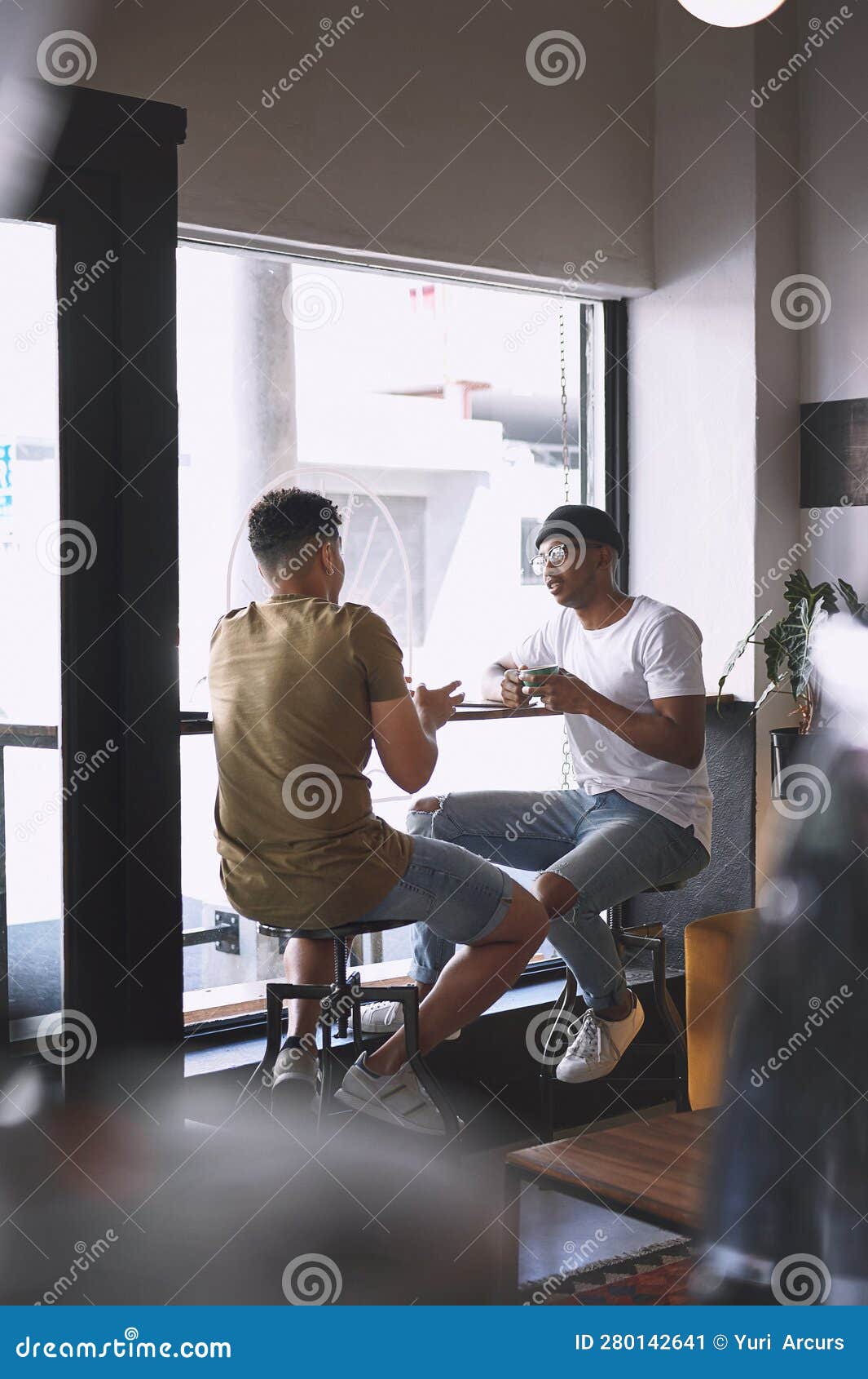 Getting To Know One Another Over Coffee. Two Young Men Talking while ...