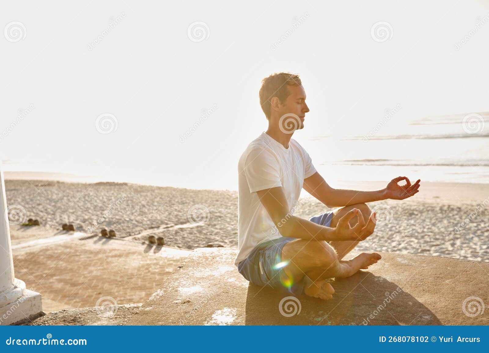 Getting in Touch with His Spiritual Side. a Man Meditating at the Beach ...