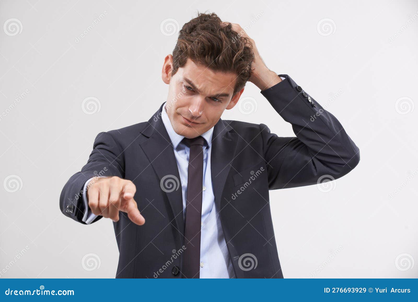 Getting in Touch with Technology. a Young Businessman Looking Confused ...